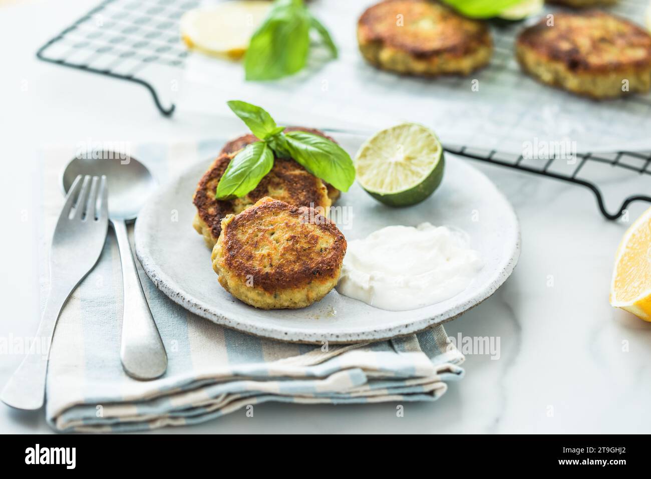 Traditional homemade fish cakes with tlemon and sour cream Stock Photo ...