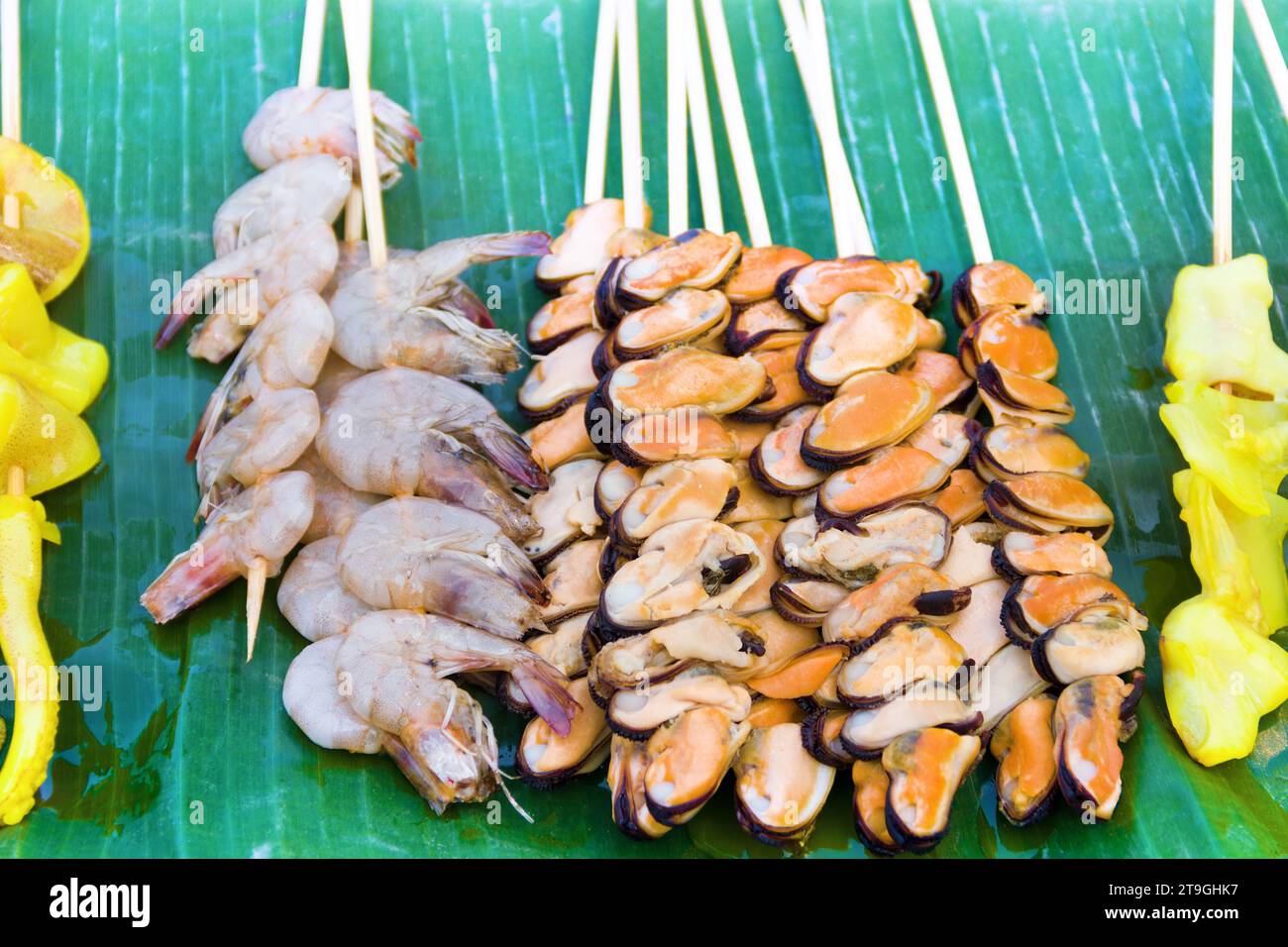Thai cuisine, exotic food. Grilled young octopuses, shrimp and ...