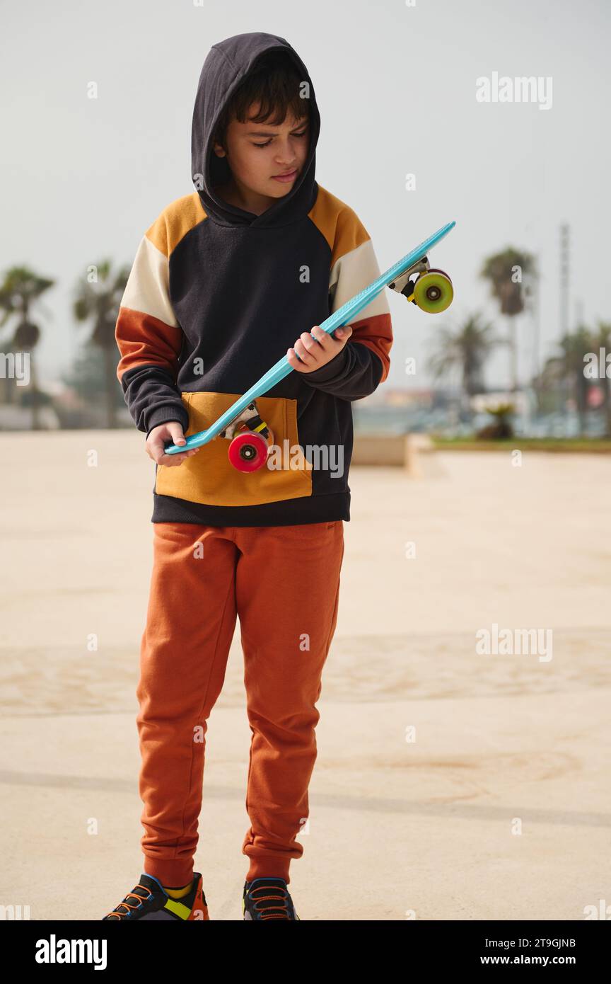 Adorable active Caucasian teenage boy dressed in stylish sportswear ...