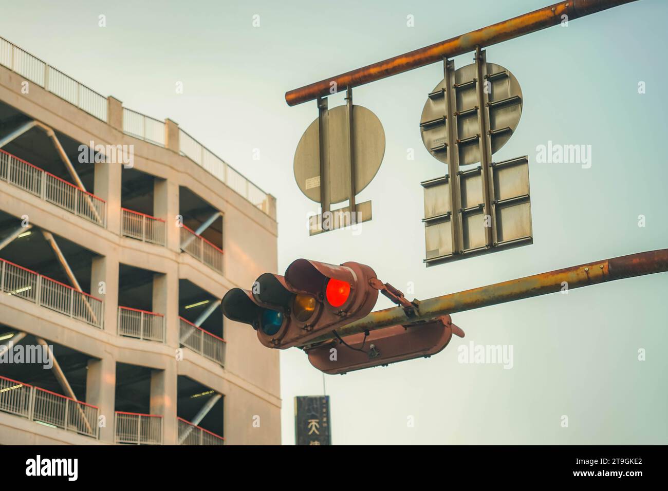 An intersection is illuminated in a spectrum of yellow and red hues ...