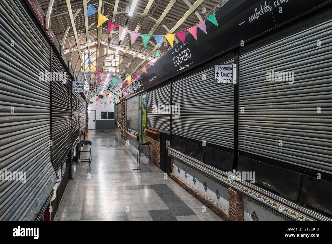 Empty hall of the central market with sales stalls closed and blinds ...