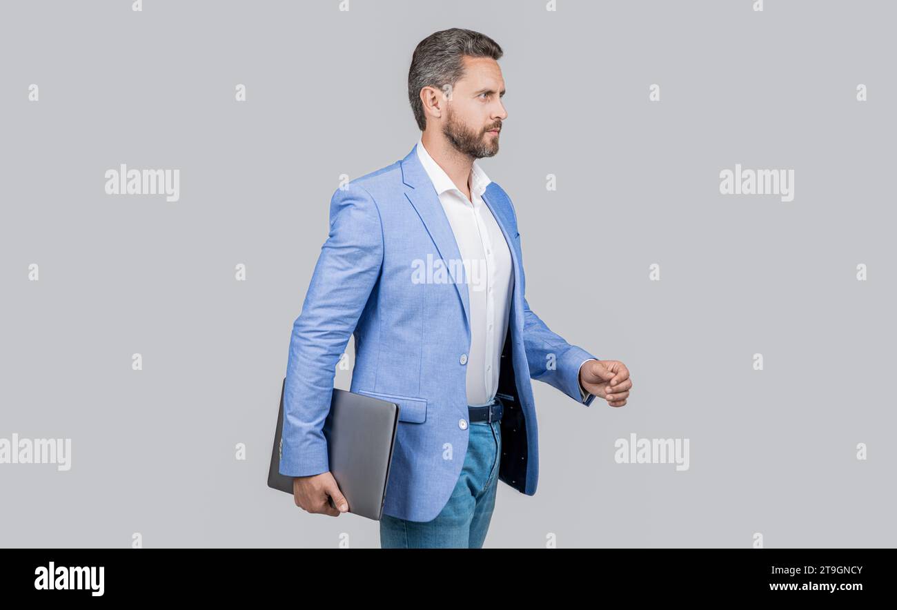 Successful businessman isolated on grey. Professional occupation of ...