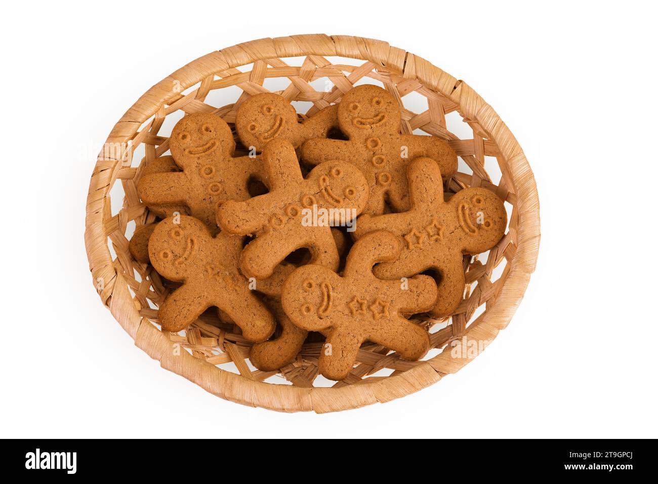 Gingerbread man in a wicker basket isolated on white background. Top ...