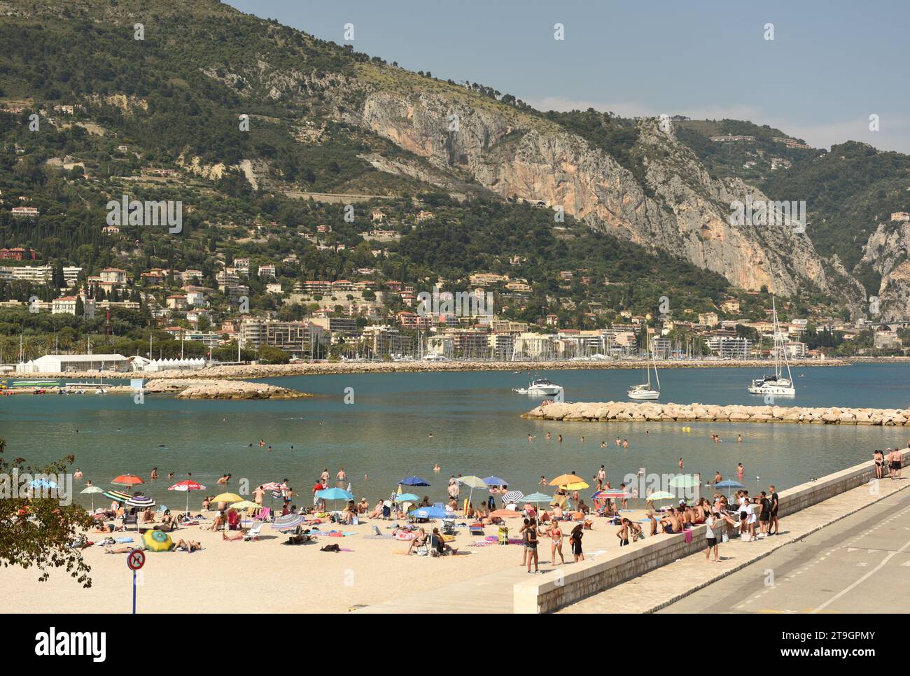 Menton, France - June 18, 2019: People rest on the beach of the Menton ...