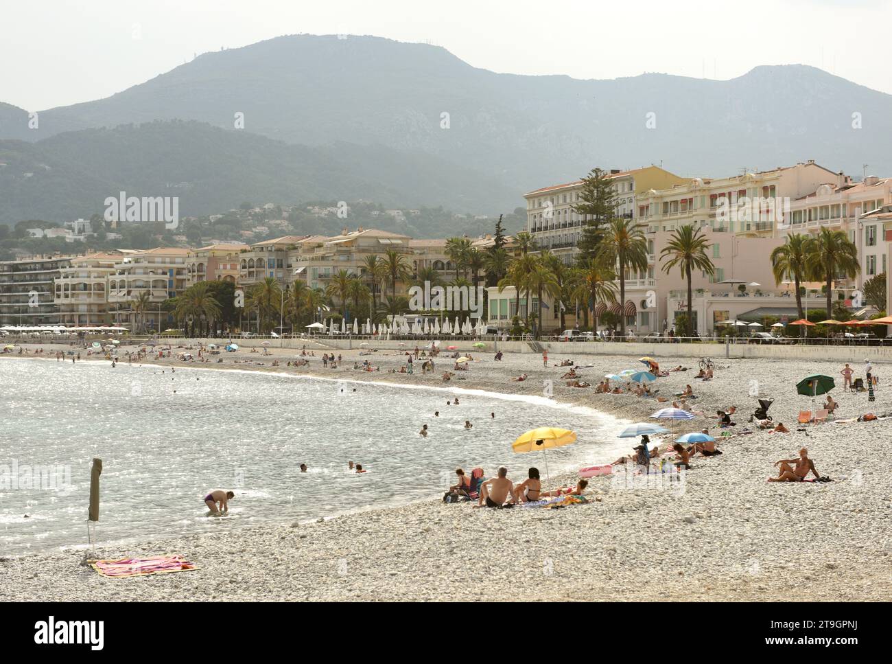 Menton, France - June 18, 2019: People rest on the beach of the Menton ...