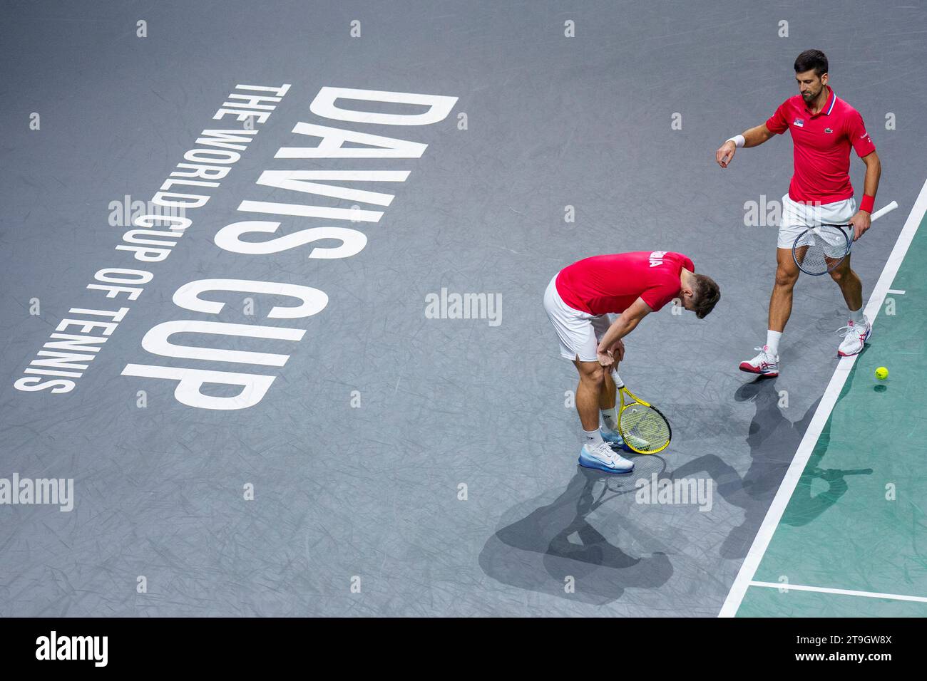 Serbia's Miomir Kecmanovic, left, and Novak Djokovic react during their match against Italy's ...