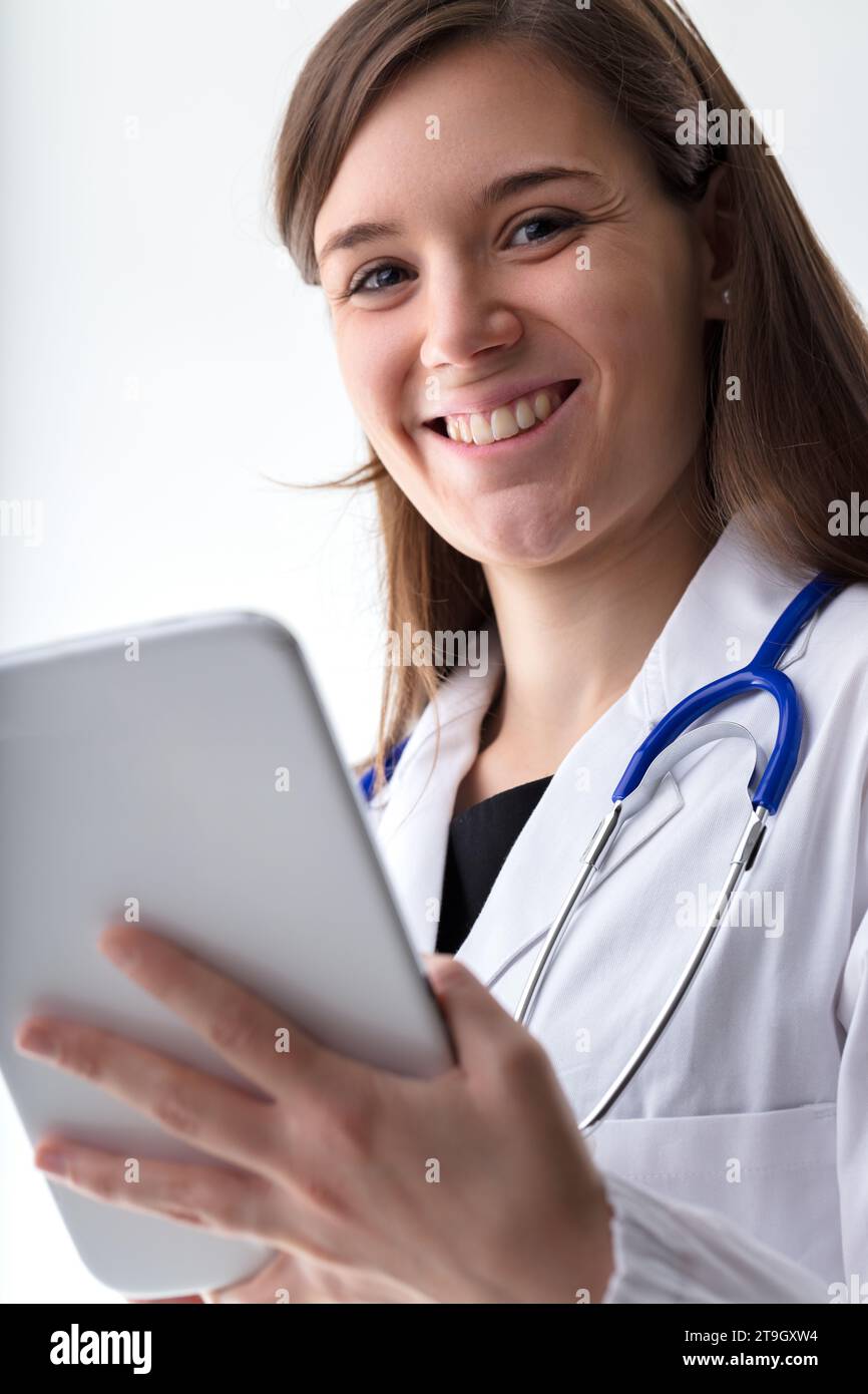 Friendly medical professional engaging with technology, her cheerful ...