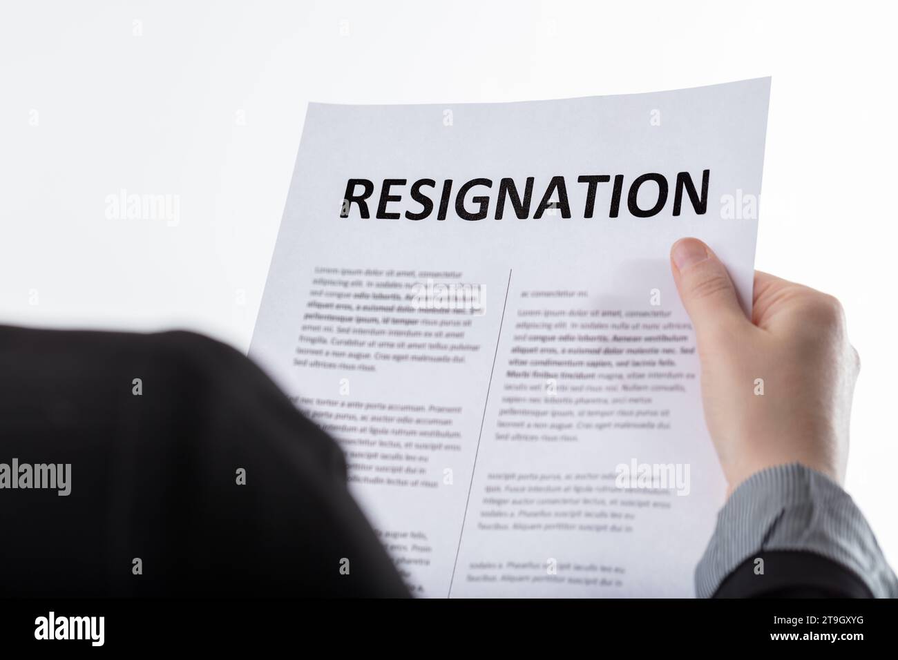 Hand holding a formal resignation letter with resolve Stock Photo - Alamy