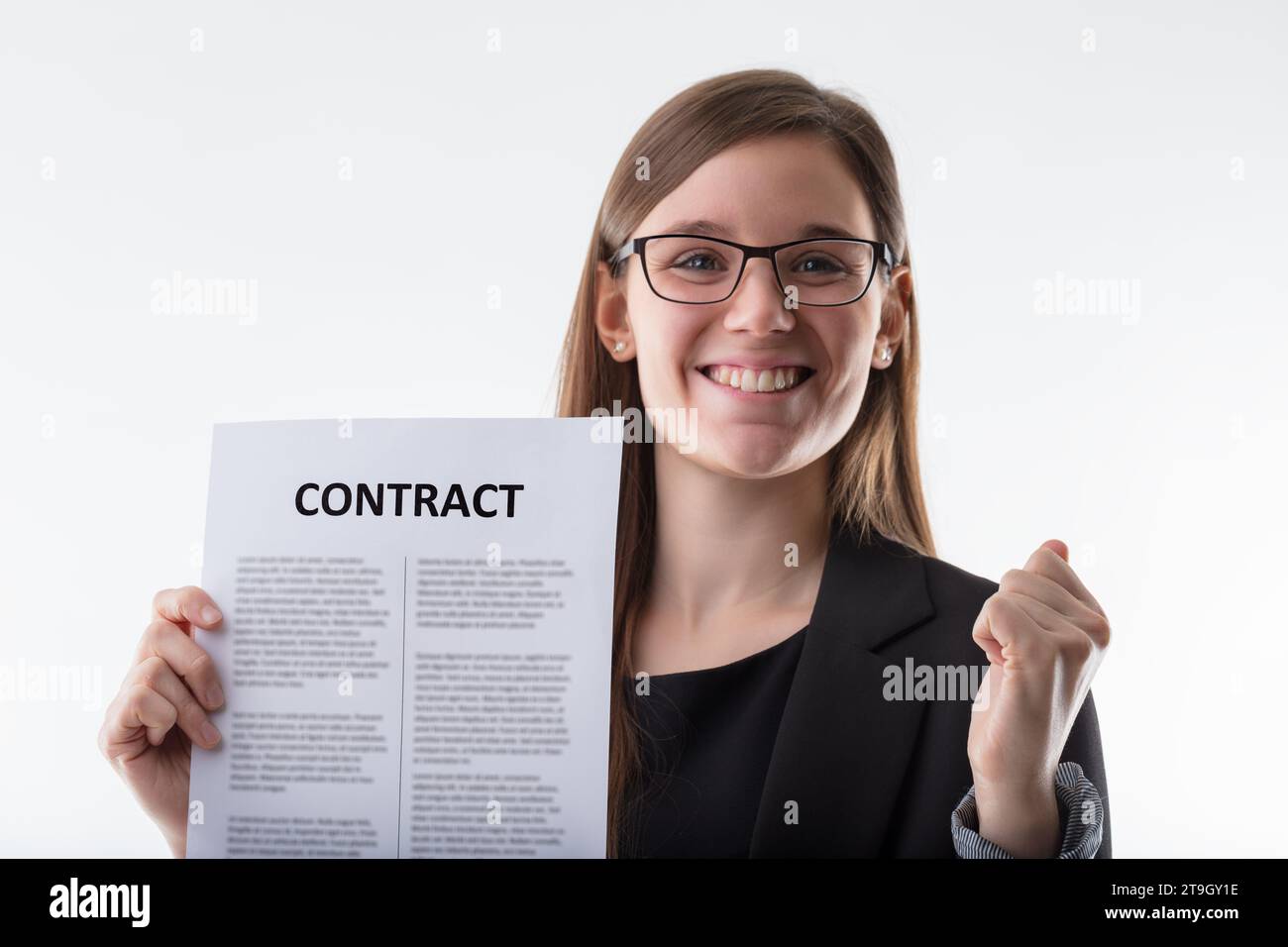 young businesswoman exudes confidence and joy as she proudly presents a freshly signed contract ...