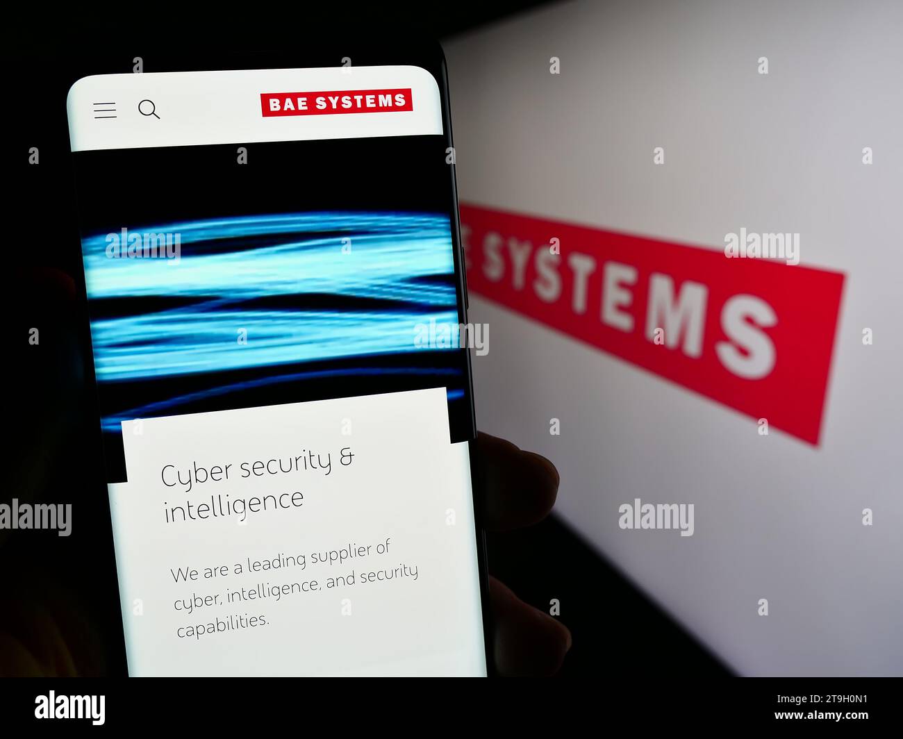 Person holding cellphone with webpage of British aerospace and defense ...