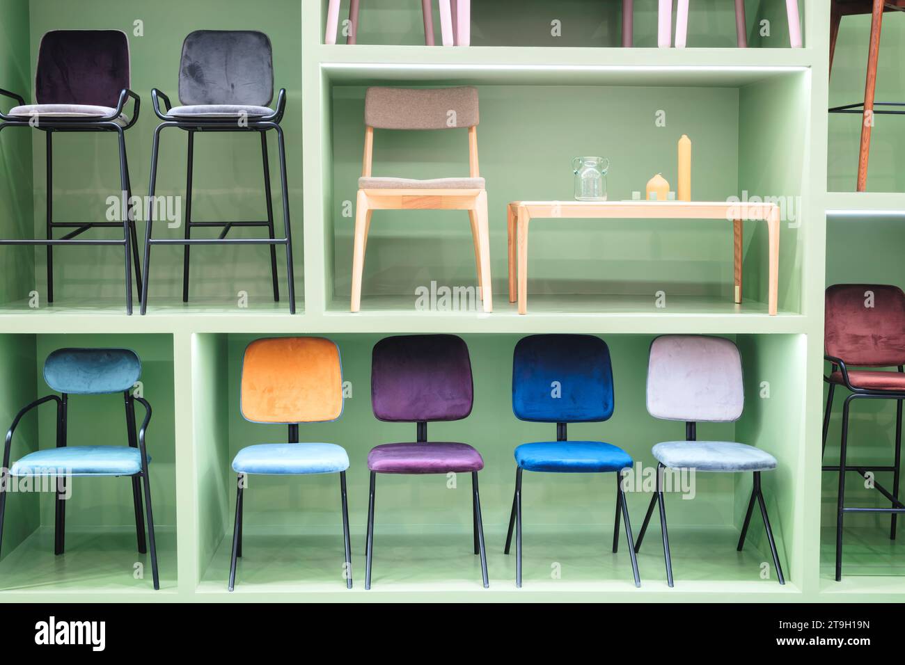 Many different chairs and armchairs on display in a furniture store ...