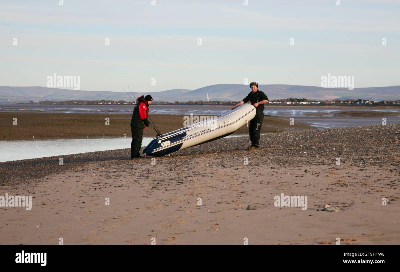 At the end of the day, two fishermen drag their boat, back along the ...