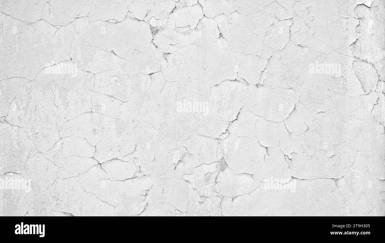 white wall with cracked paint as a textured abstract background for a ...