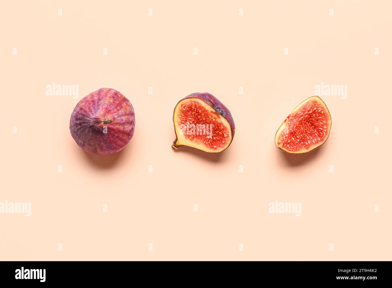Fresh juicy cut figs on pale pink background Stock Photo - Alamy