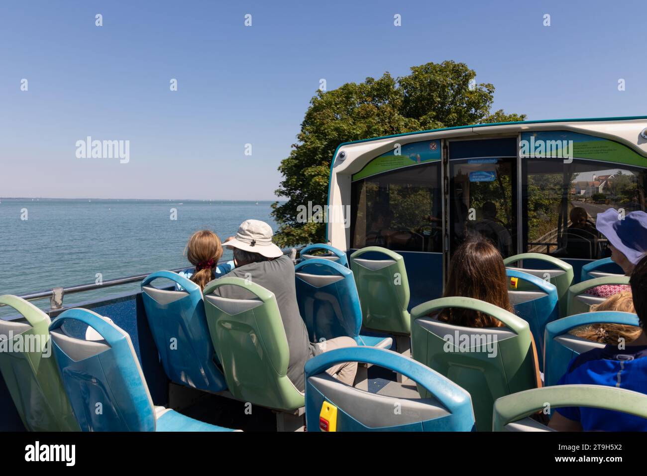 Open top tourist bus ride by the sea on the Isle of Wight, England ...