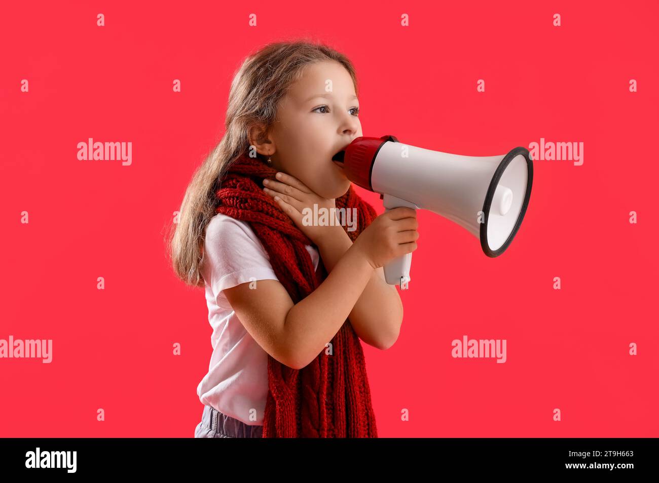 Sick little girl shouting into megaphone on red background Stock Photo ...
