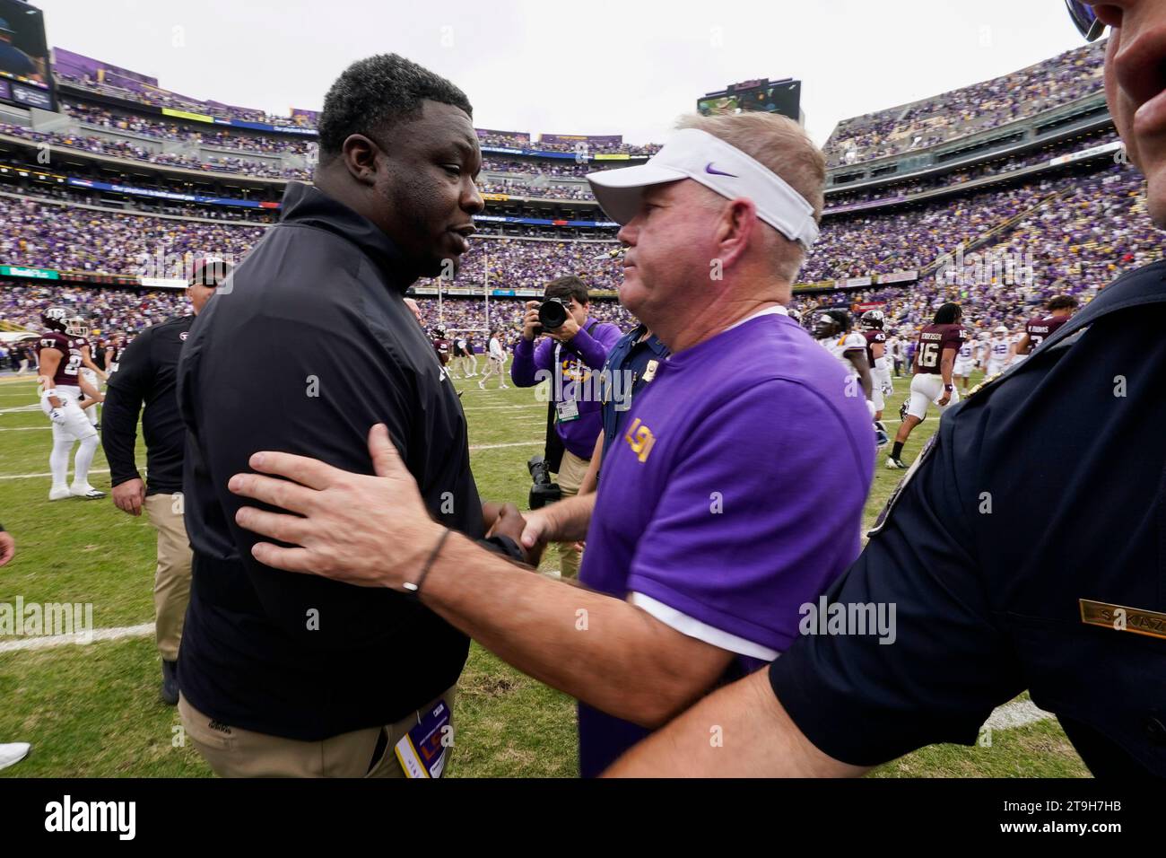LSU head coach Brian Kelly, right, greets Texas A&M interim head coach ...