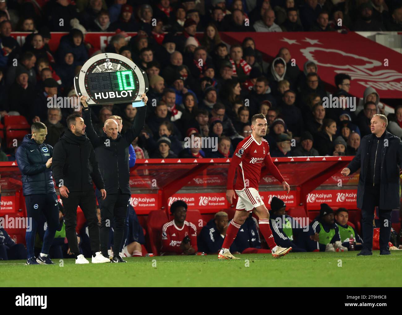 The fourth official holds up the board hi-res stock photography and ...