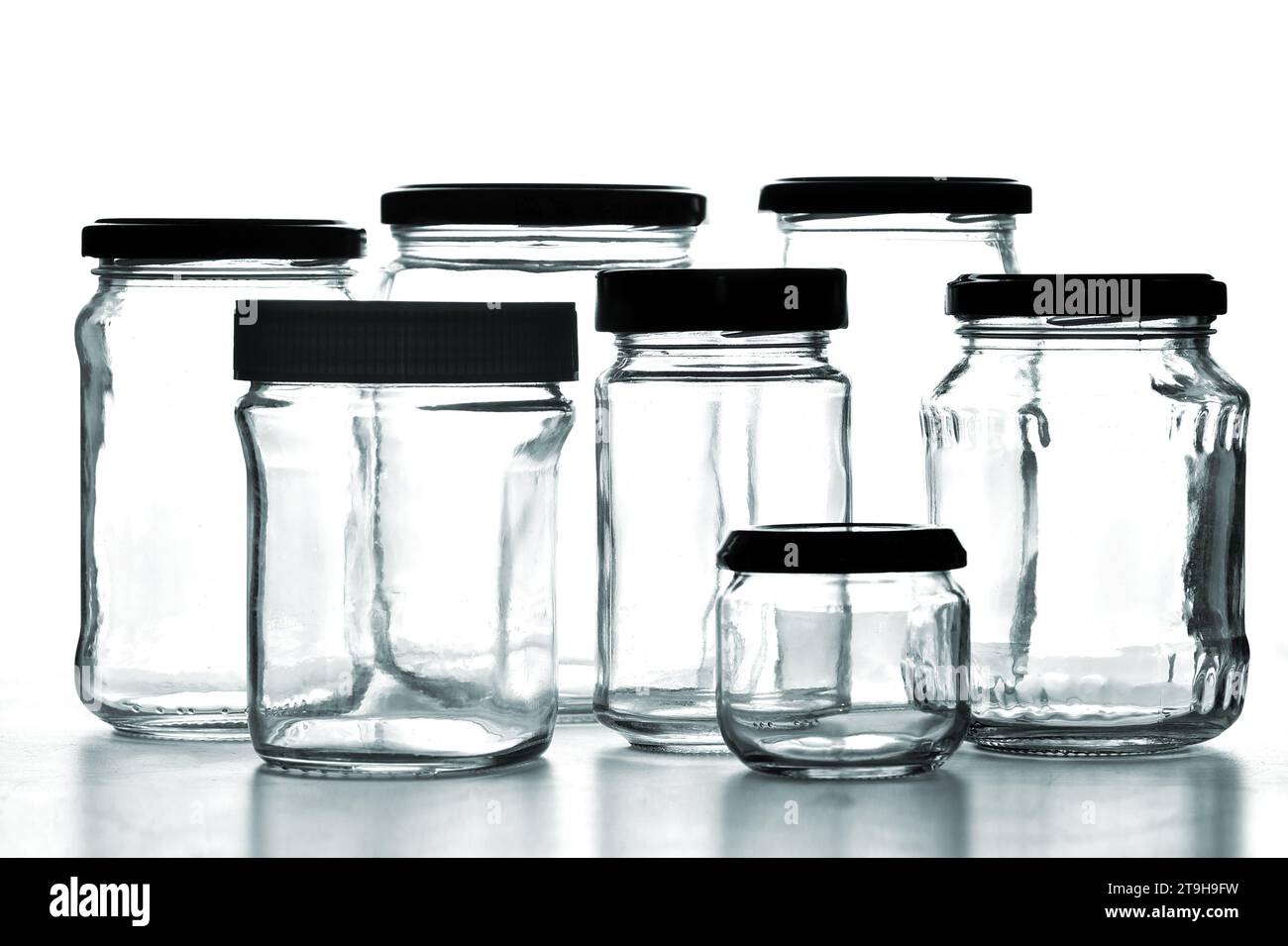 Empty transparent glass jar collection with lid on white background ...