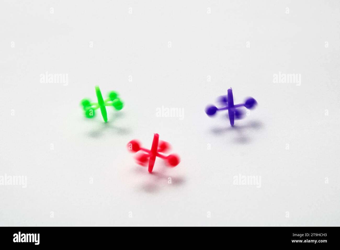 Three moving jack game pieces Stock Photo - Alamy