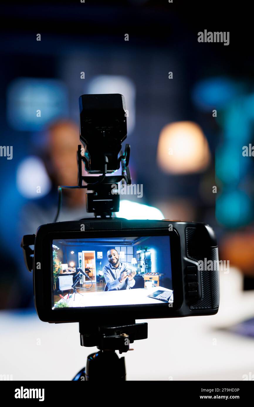 Focus on professional camera capturing footage of content creator in ...