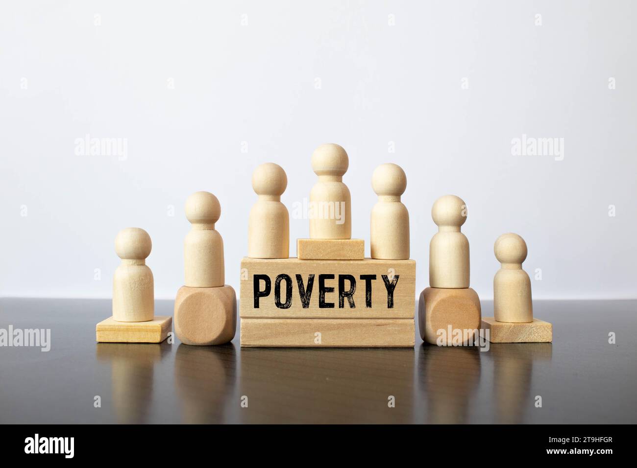 Poverty word written on wood block. Poverty text on cement table for ...