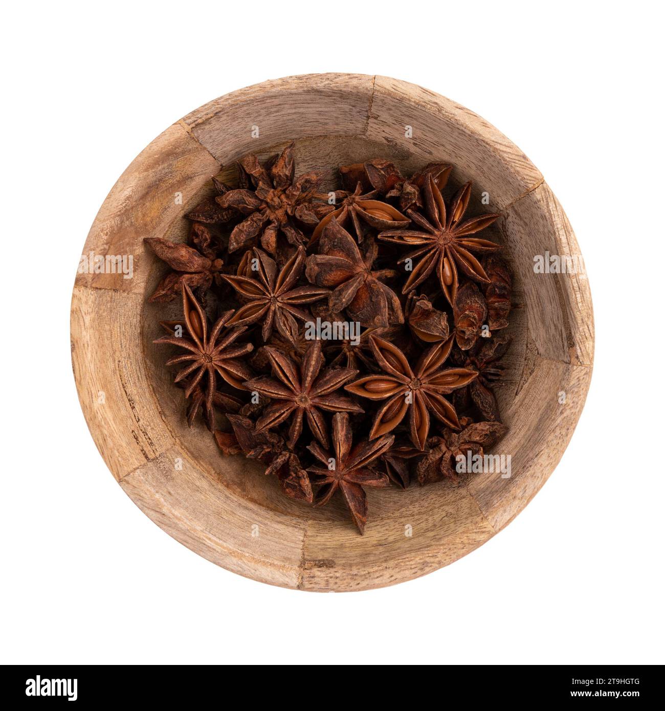 heap of star anise in wooden bowl isolated on white background ...
