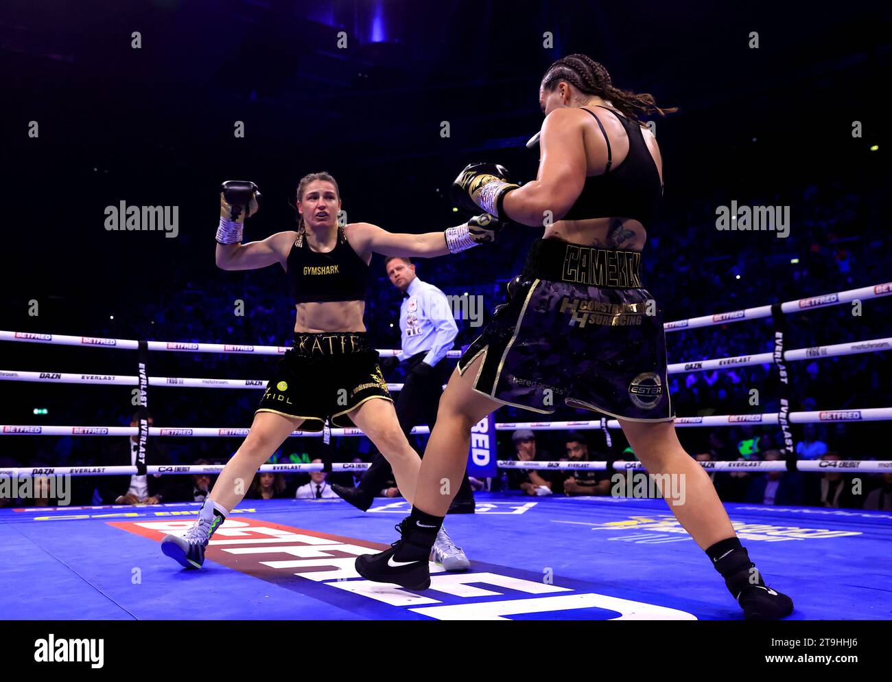 Katie Taylor (left) falls down during her Undisputed Super Lightweight ...