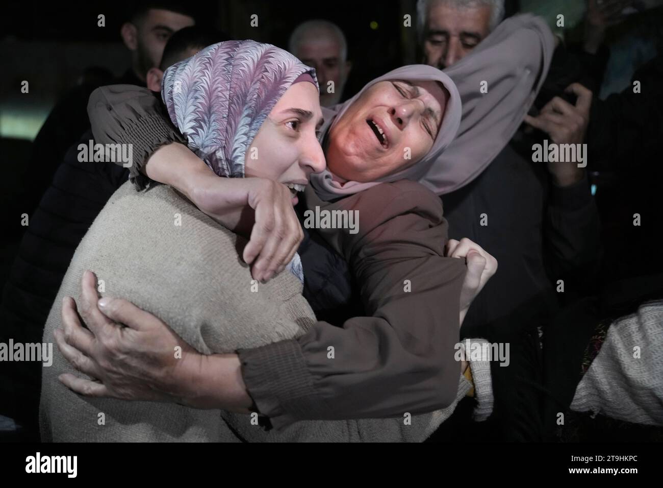 Shuruq Dwayat, left, a Palestinian prisoner released by Israel, is hugged by relatives as she ...