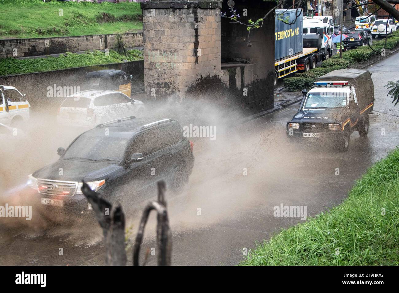 Nakuru, Kenya. 25th Nov, 2023. A vehicle splashes storm water on a ...