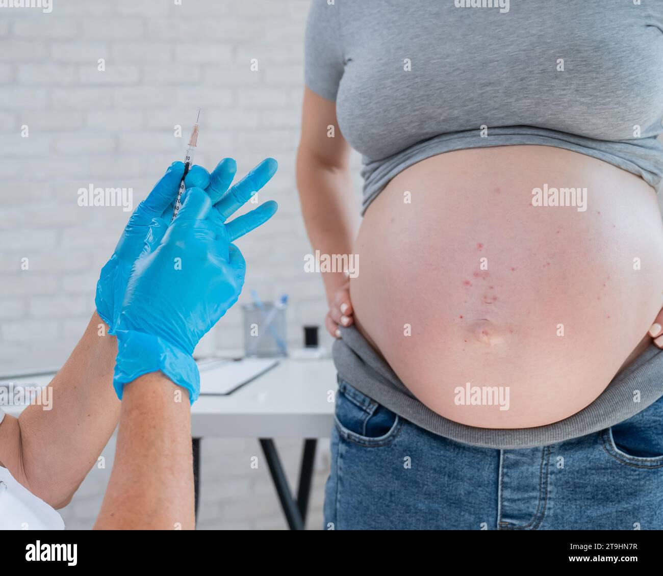Doctor gives an injection in the stomach of a pregnant woman Stock ...