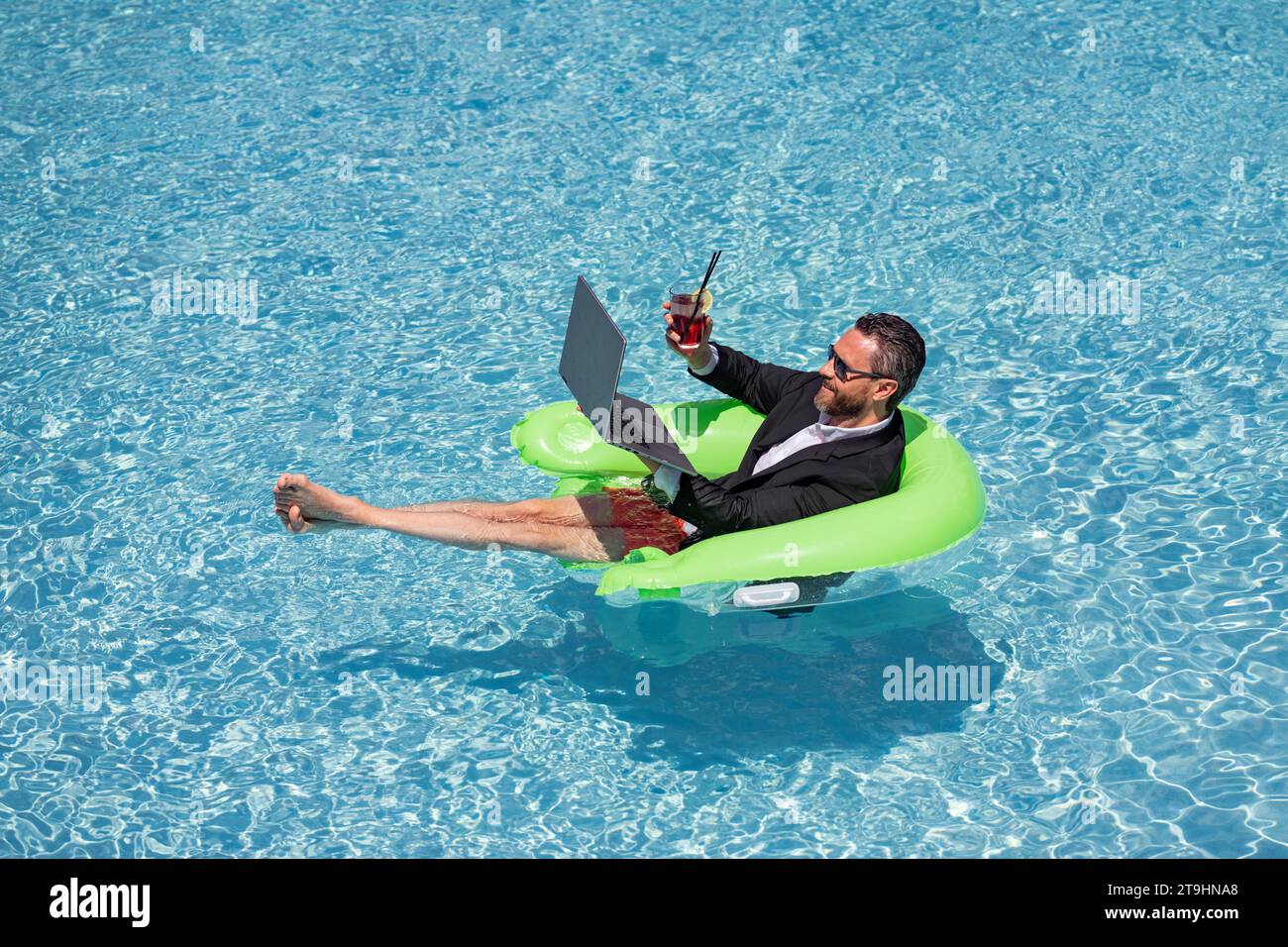 Handsome man floating in pool hi-res stock photography and images - Alamy