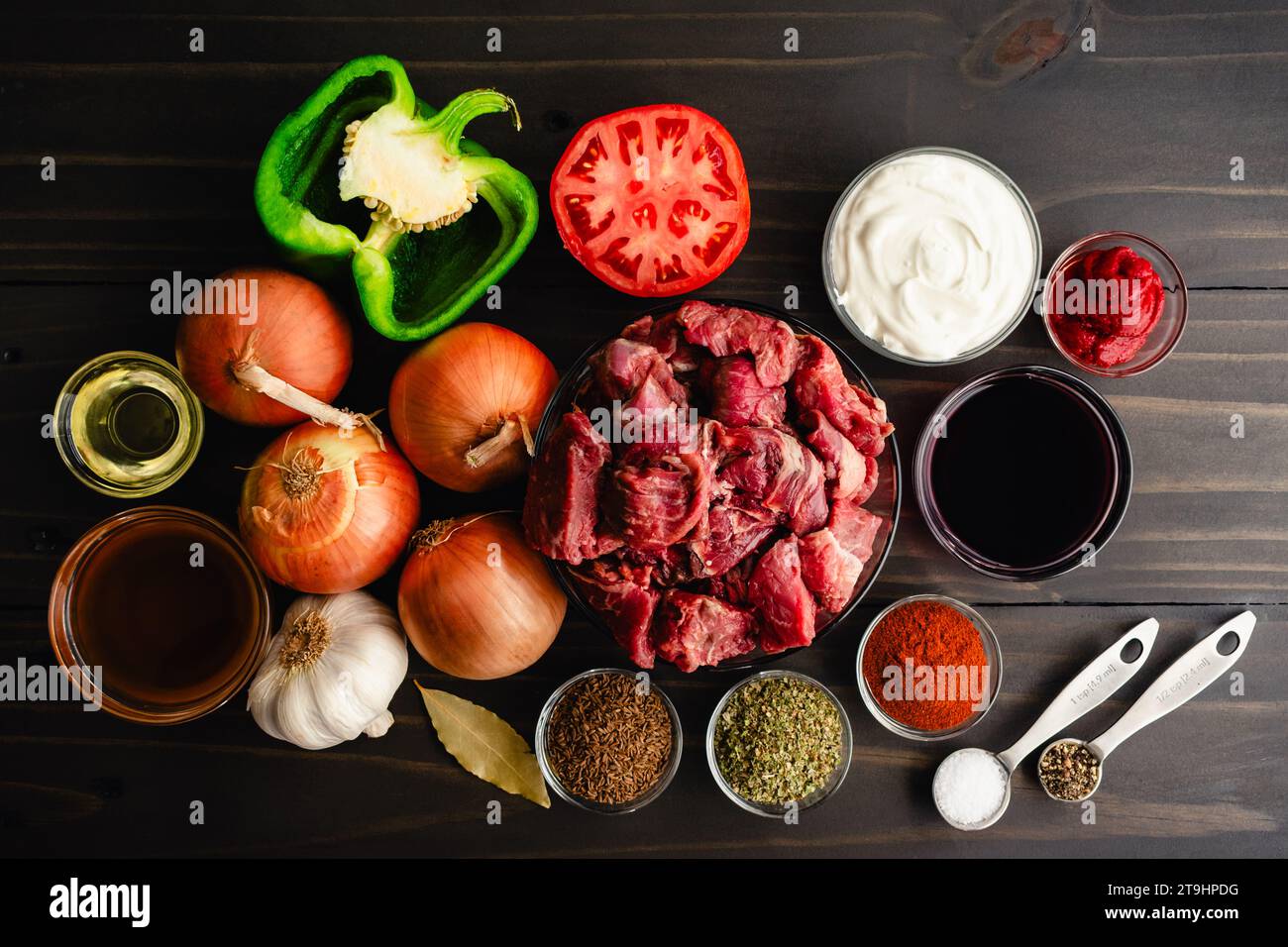 German Goulash Ingredients on a Dark Wooden Table Background: Stew meat ...