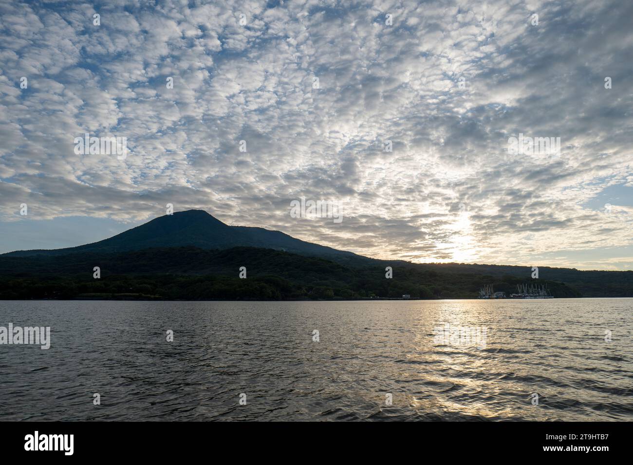 Dark Coastline Seen From Afar with Volcanic Mountain Ranges with Lush ...