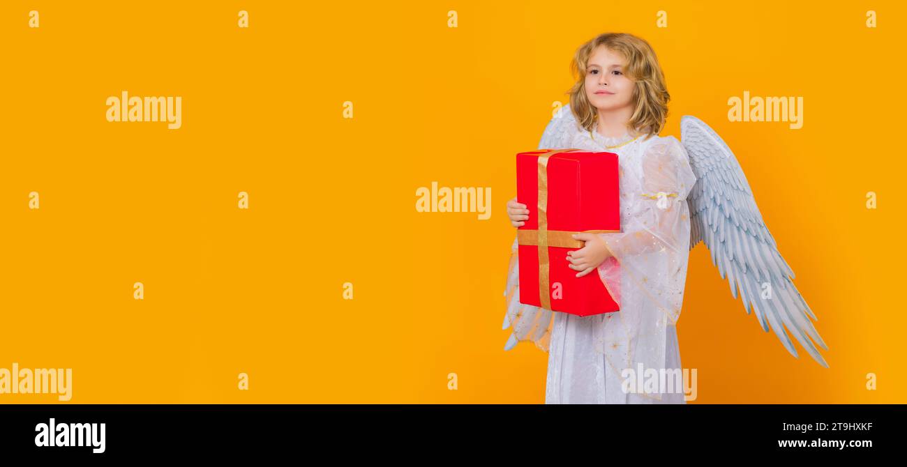 Angel kid with gift box present. Kid wearing angel costume white dress ...