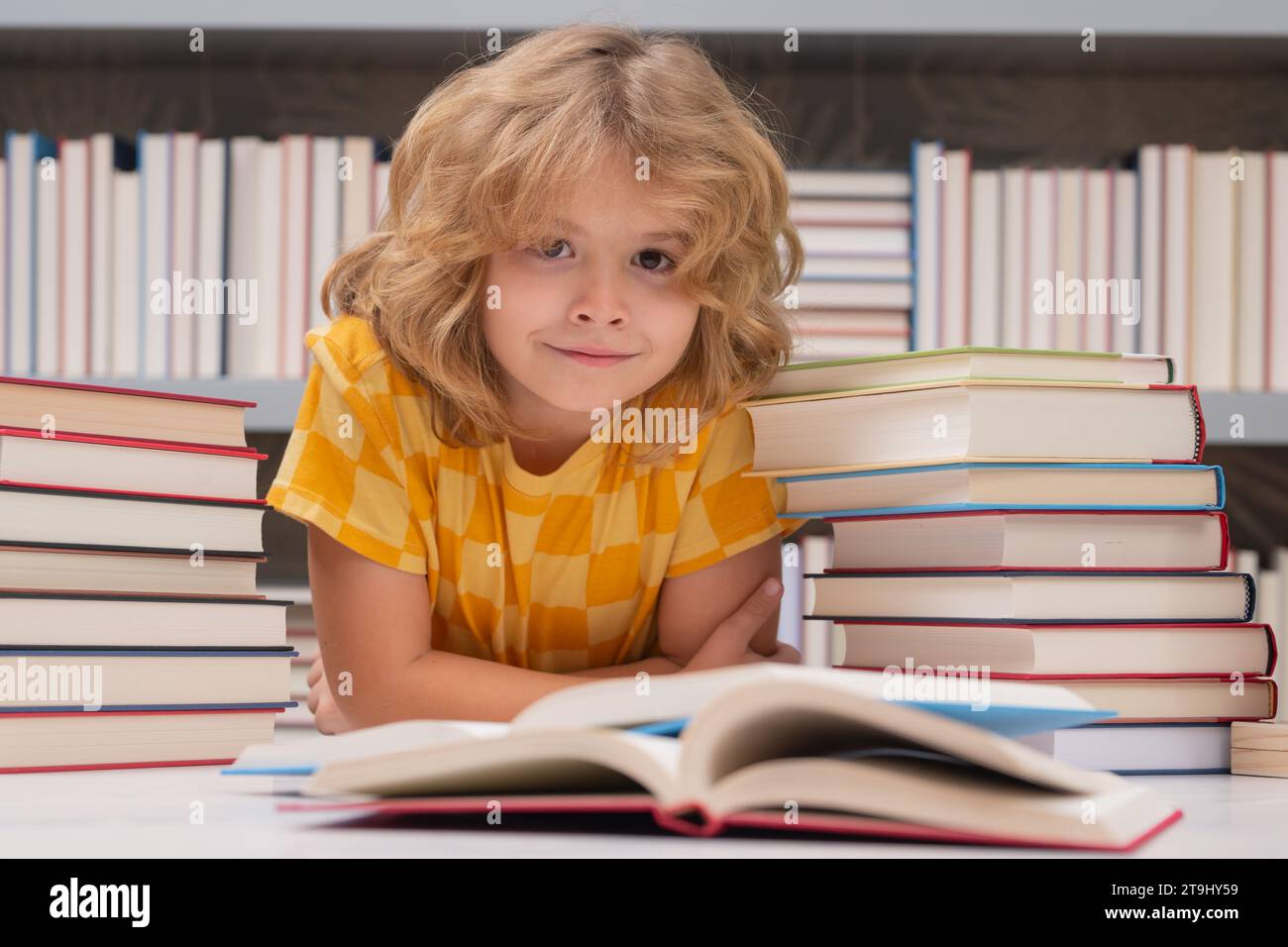 Pupil with pile of books. Children enjoying book story in school ...