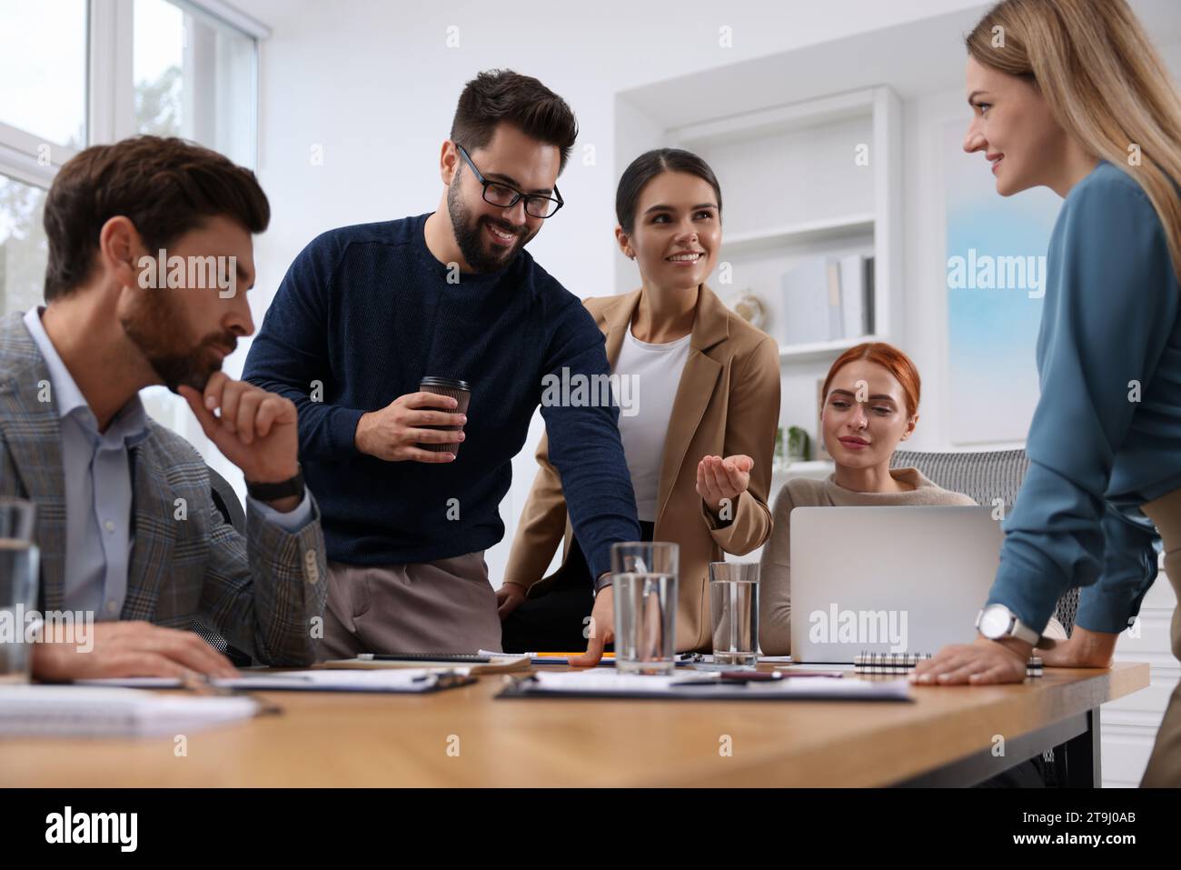 Team of employees working together in office Stock Photo - Alamy