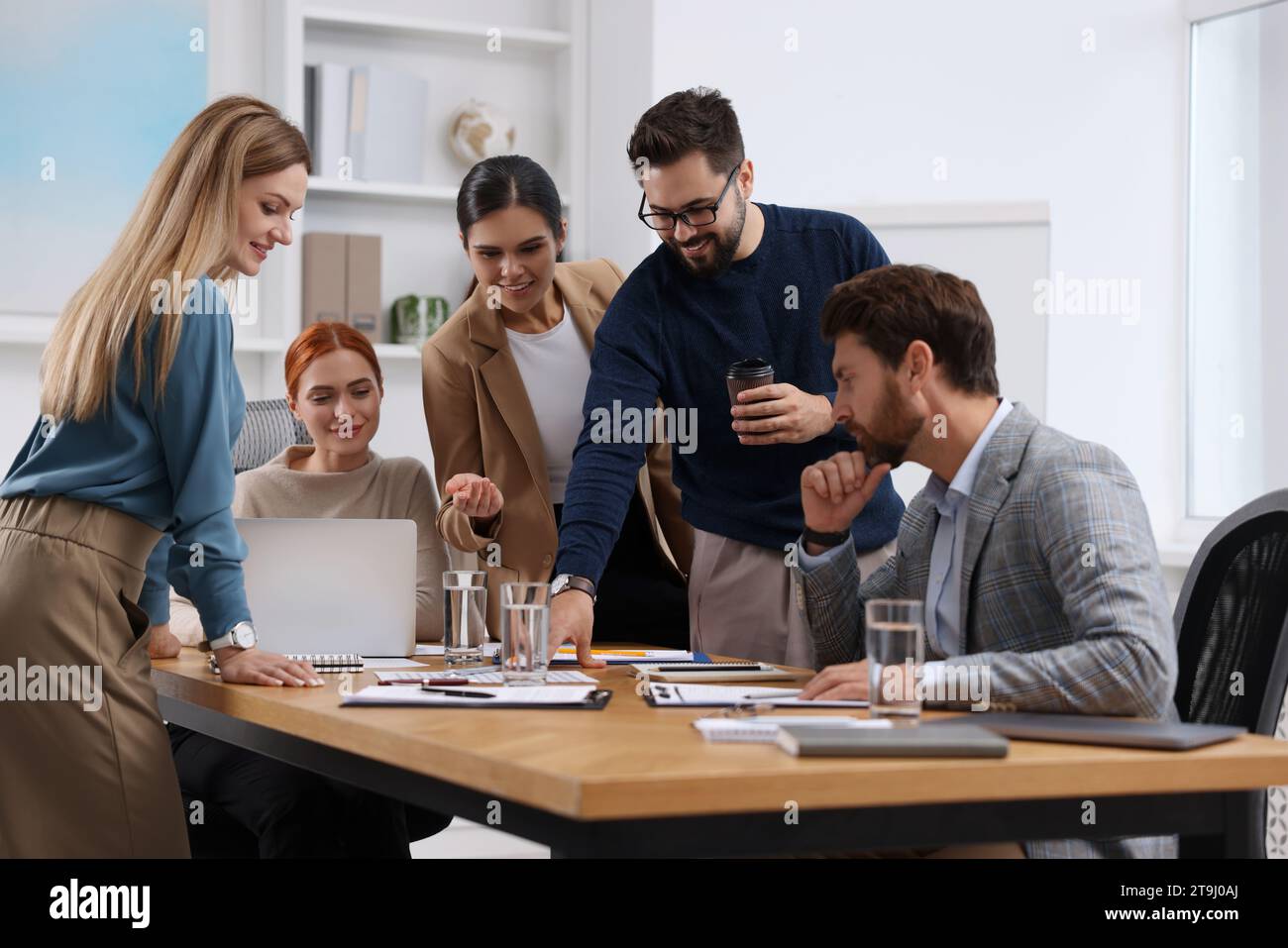 Team of employees working together in office Stock Photo - Alamy