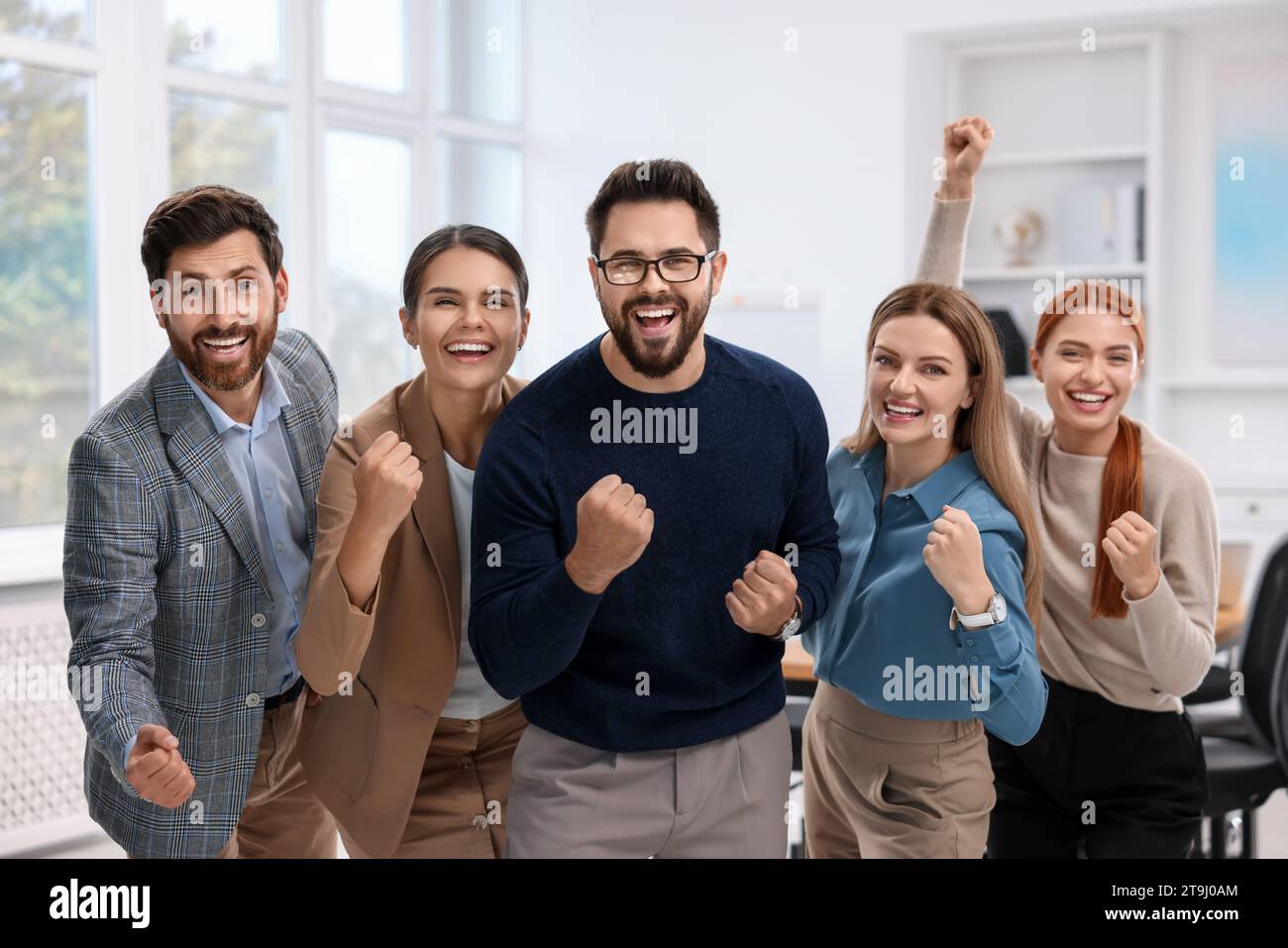 Team of employees celebrating success in office Stock Photo - Alamy