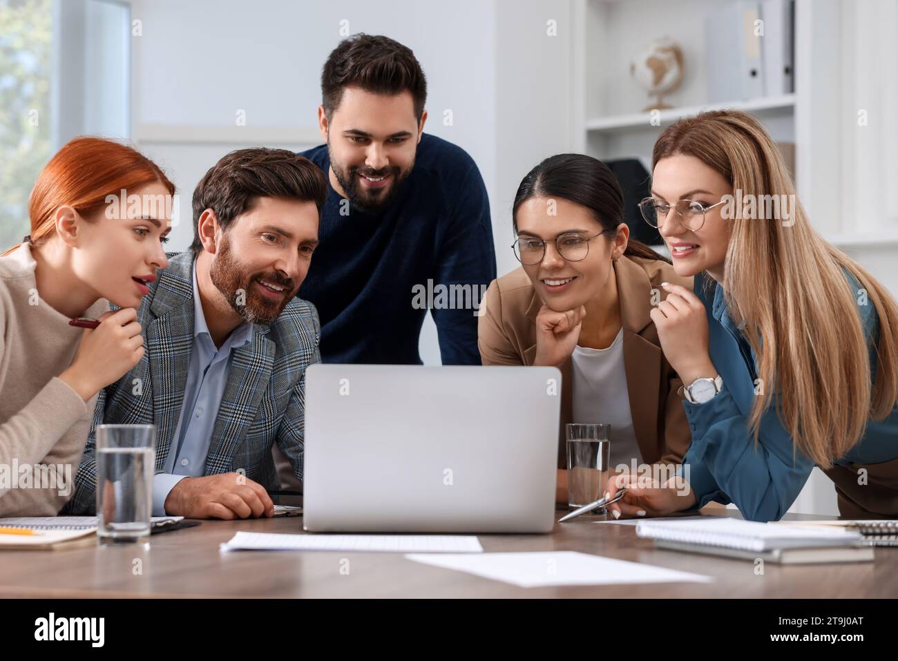 Team of employees working together in office Stock Photo - Alamy