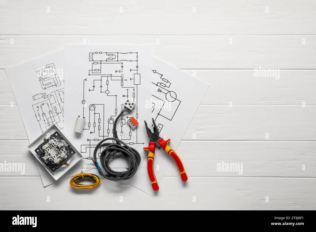 Wiring diagrams, wires, pliers and disassembled light switch on white ...