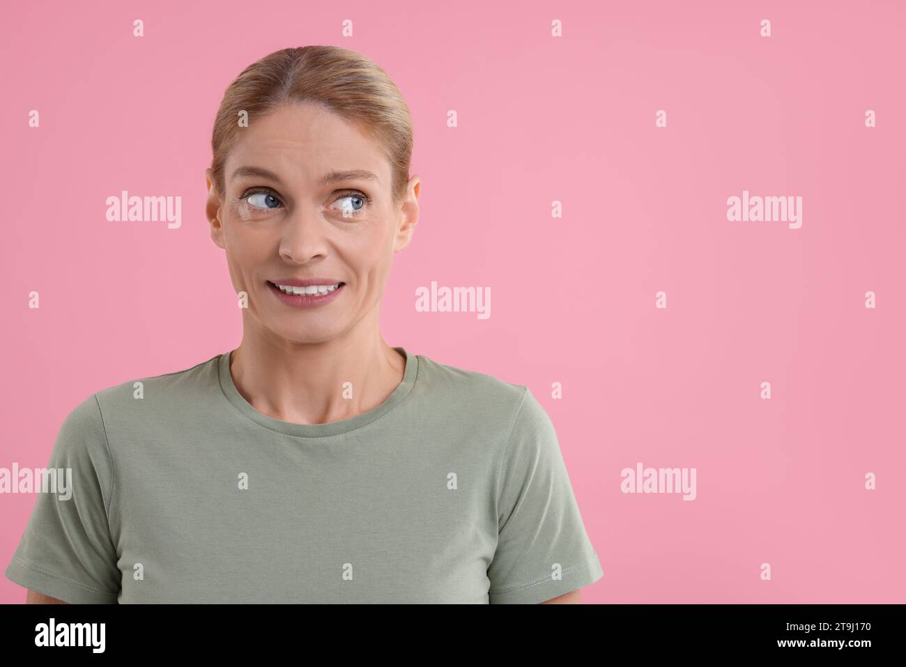 Embarrassed woman on pink background. Space for text Stock Photo - Alamy