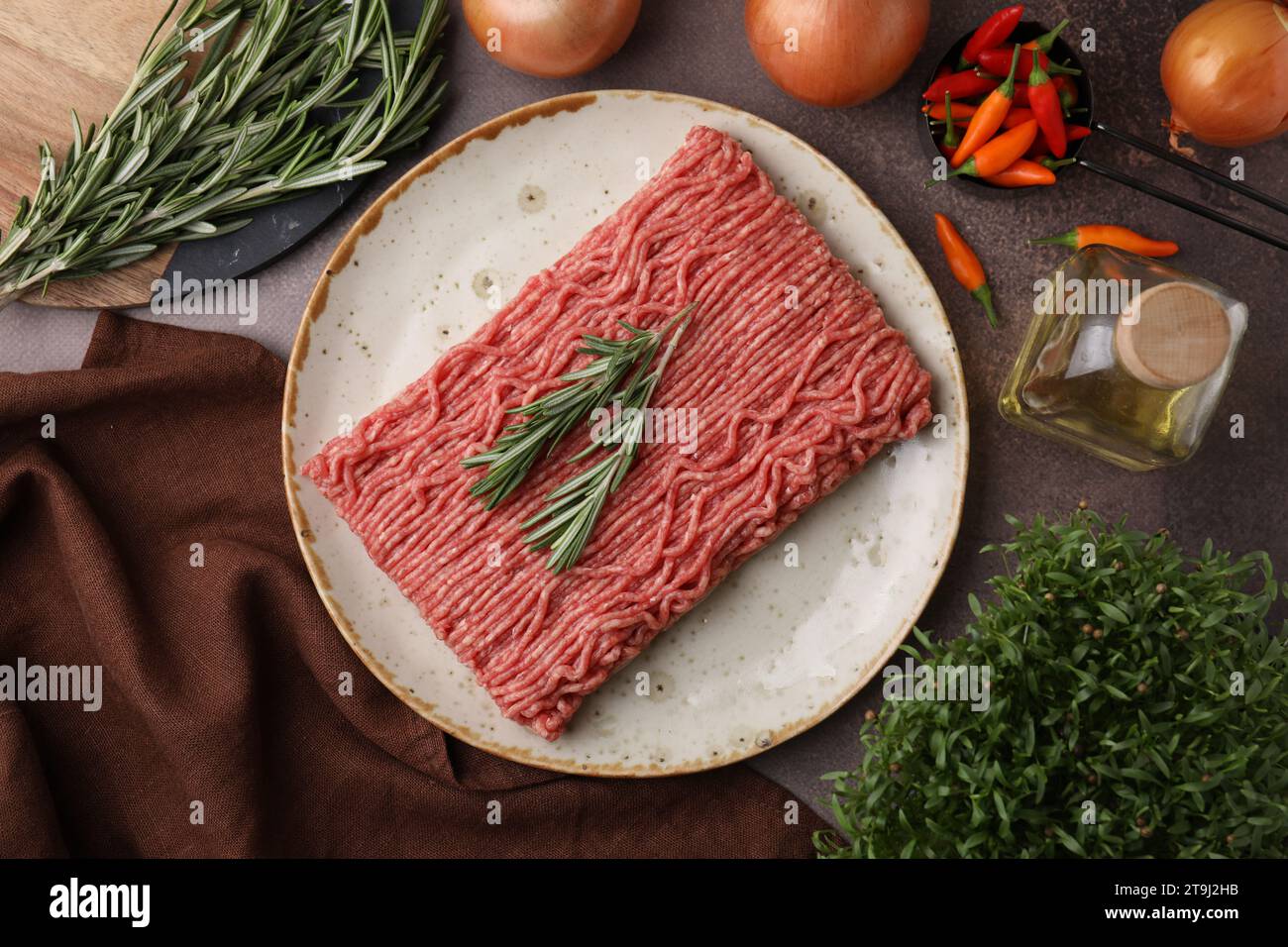 Flat lay composition with fresh raw ground meat, herbs and products on ...