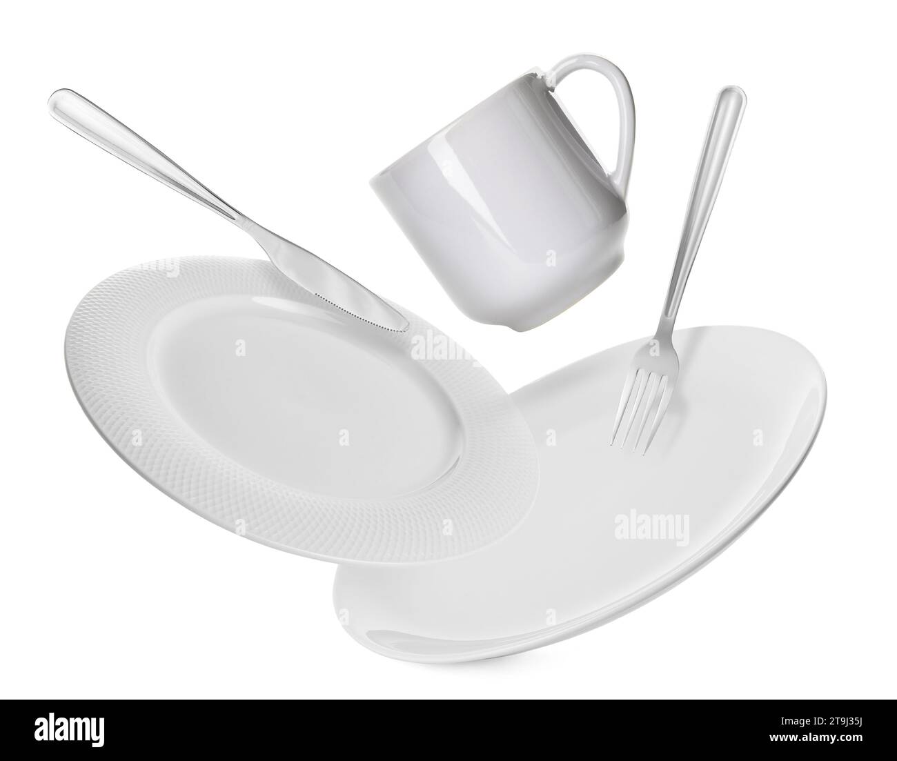 Clean plates, fork, knife and cup falling on white background Stock ...