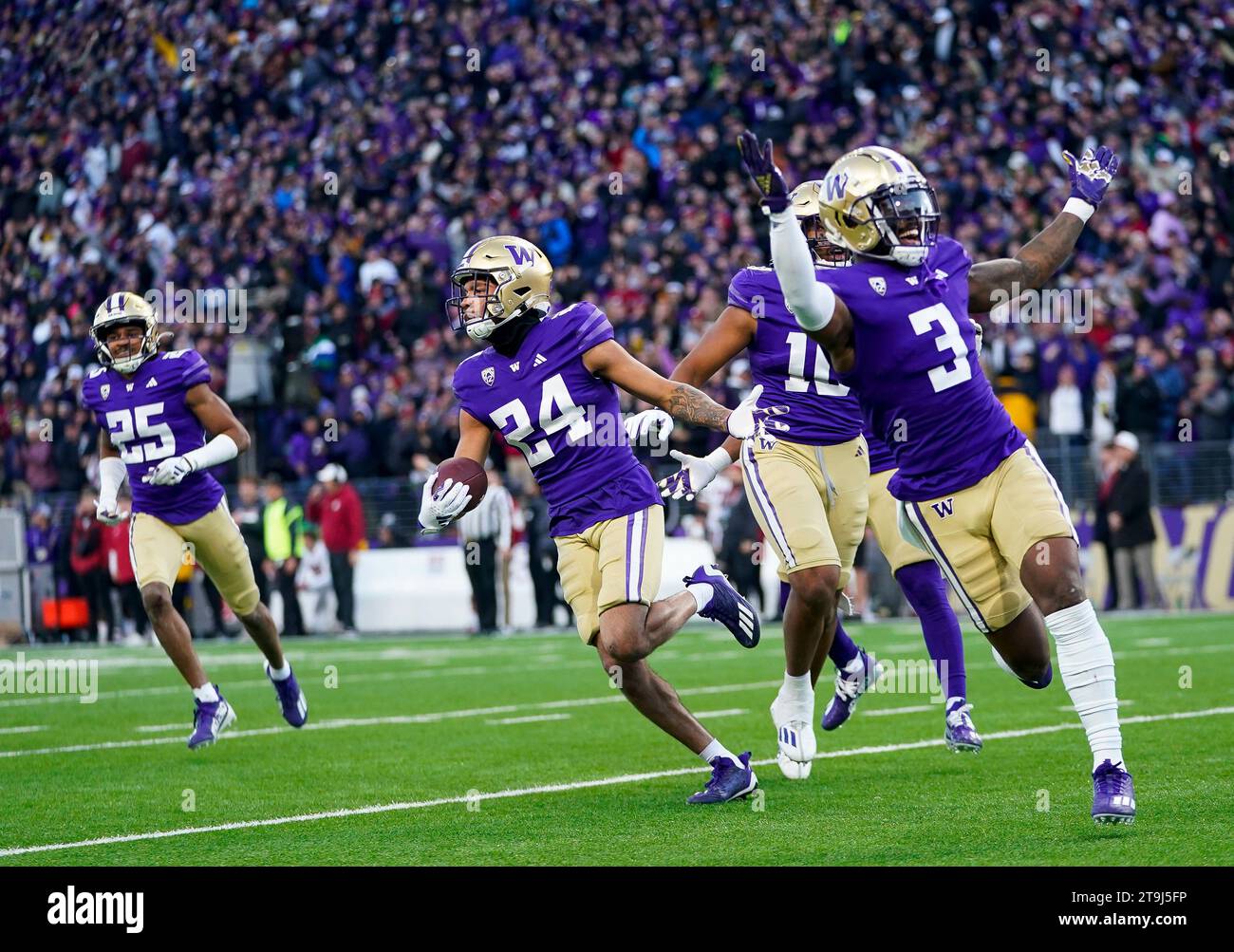 Washington safety Makell Esteen (24) runs with safety Mishael Powell (3 ...