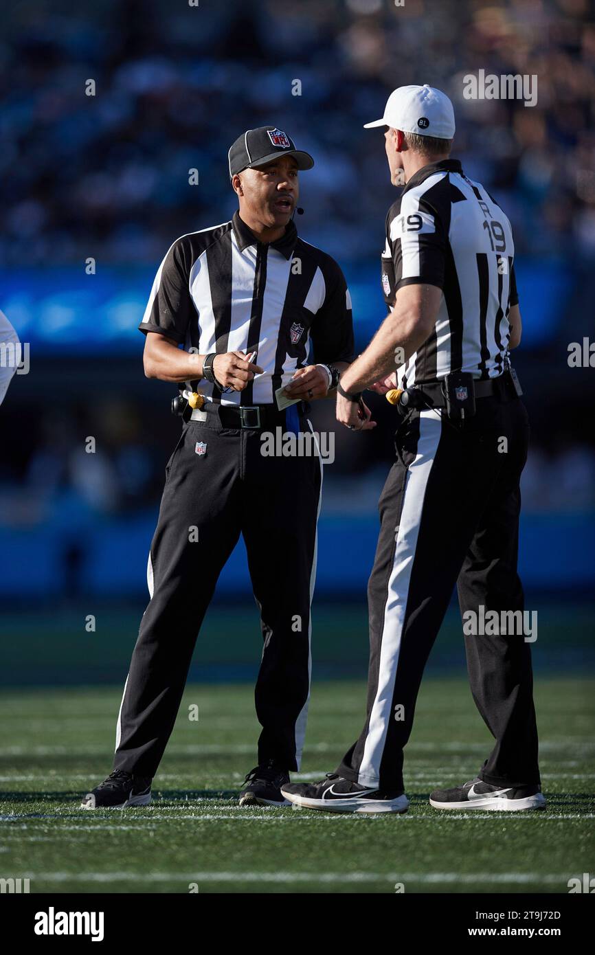 Umpire James Carter (73) chats with referee Clay Martin (19) during an ...