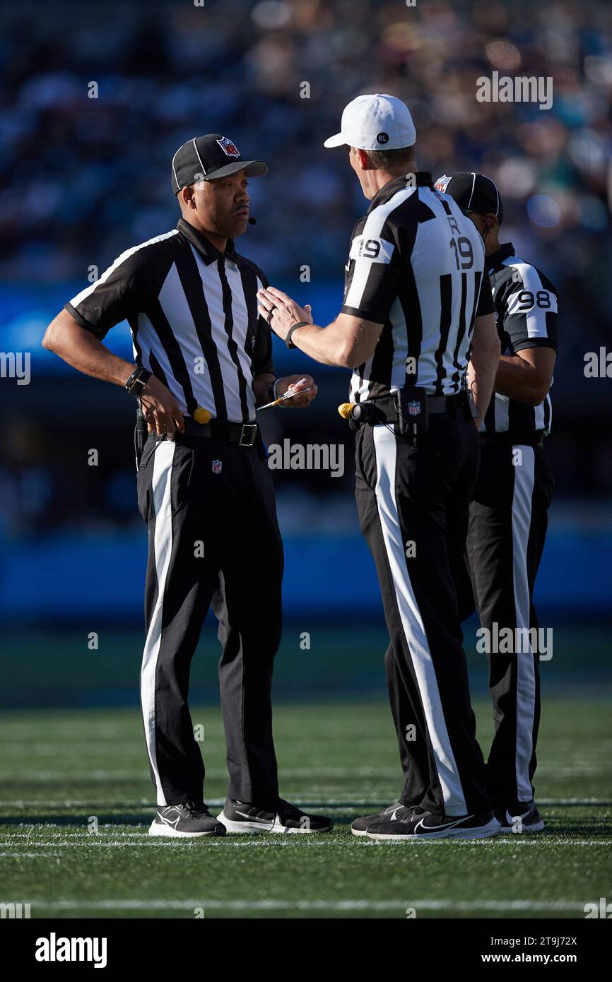 Umpire James Carter (73) chats with referee Clay Martin (19) during an ...