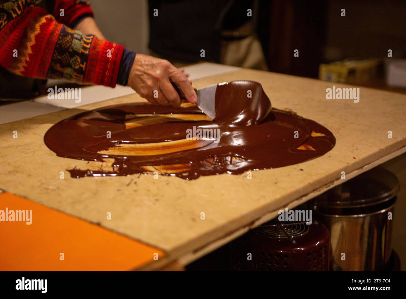 Chocolatier spreading chocolate as a demonstration Stock Photo - Alamy