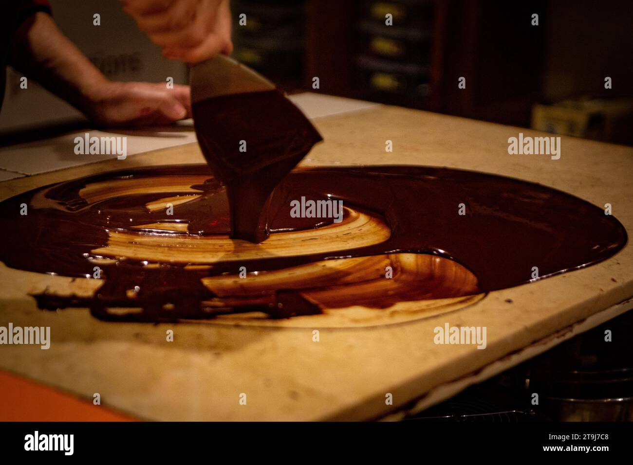 Chocolatier mixing melted liquid chocolate hi-res stock photography and ...
