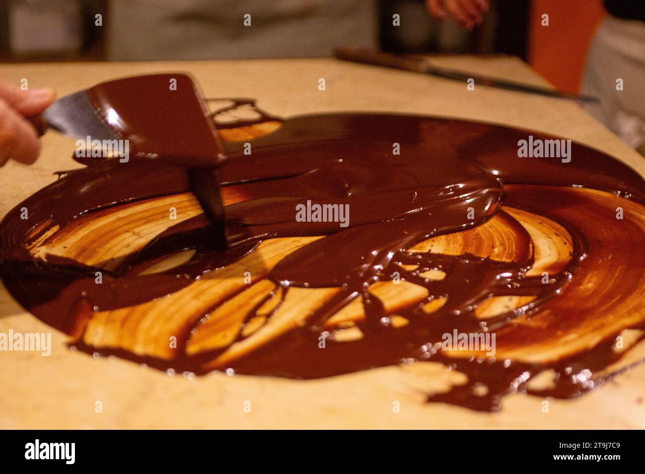 Chocolatier spreading chocolate as a demonstration Stock Photo - Alamy
